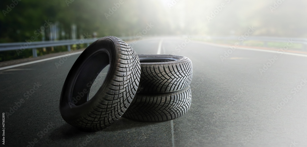 Winter tires on a asphalt road. Four wheel off. Change a summer tyre ...