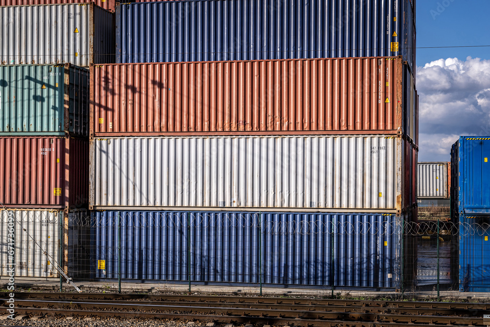 Colored stacked 40ft unmarked freight containers at a railway container ...