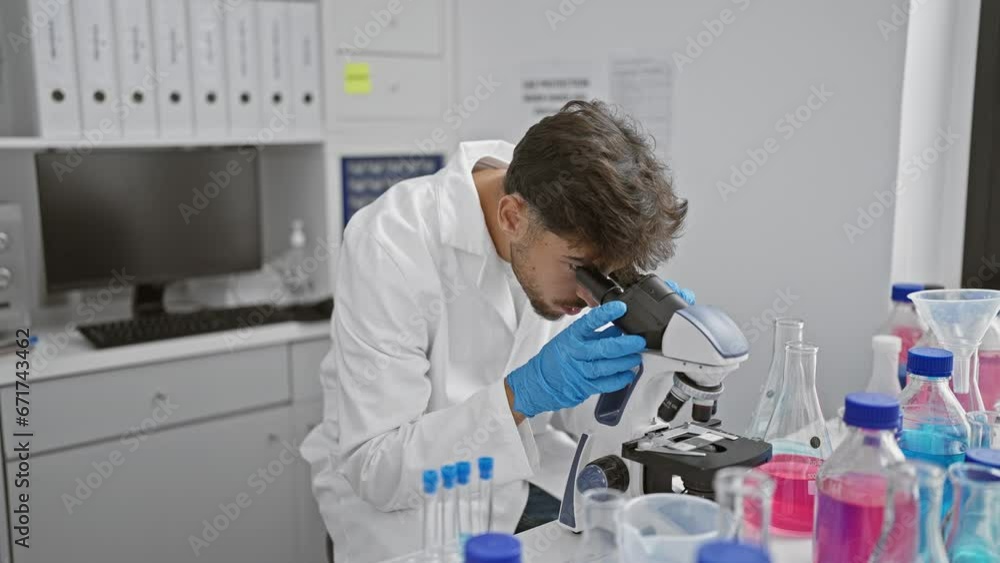 Handsome, young arabian scientist in distress, upset in laboratory over unsettling medical ...