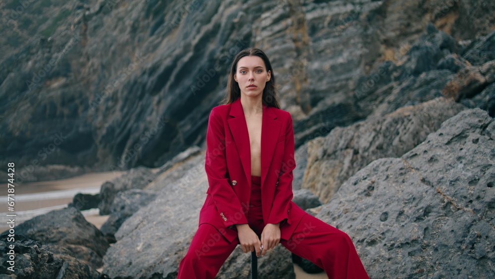 Elegant lady posing beach gloomy day. Elegant girl sitting on chair at ...