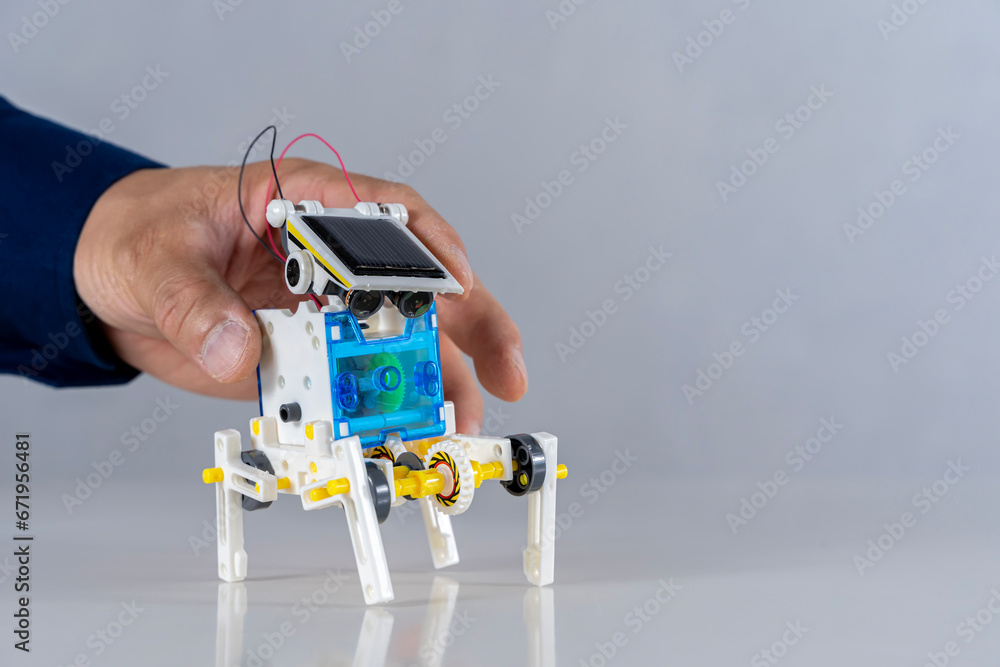 Students hands learning a robot from plastic details, programming on a ...