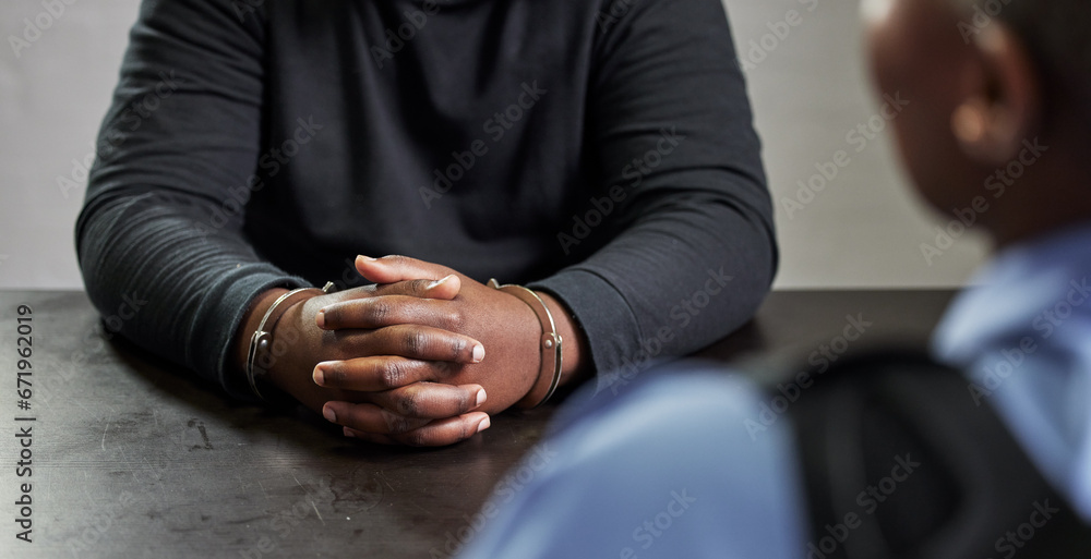 Criminal, hands and handcuffs and table for interrogation, questions or accusation with officer ...