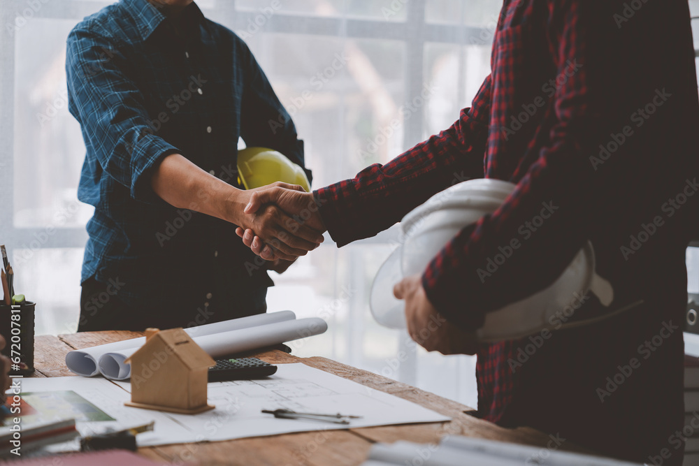 Architect and engineer construction workers shaking hands after ...