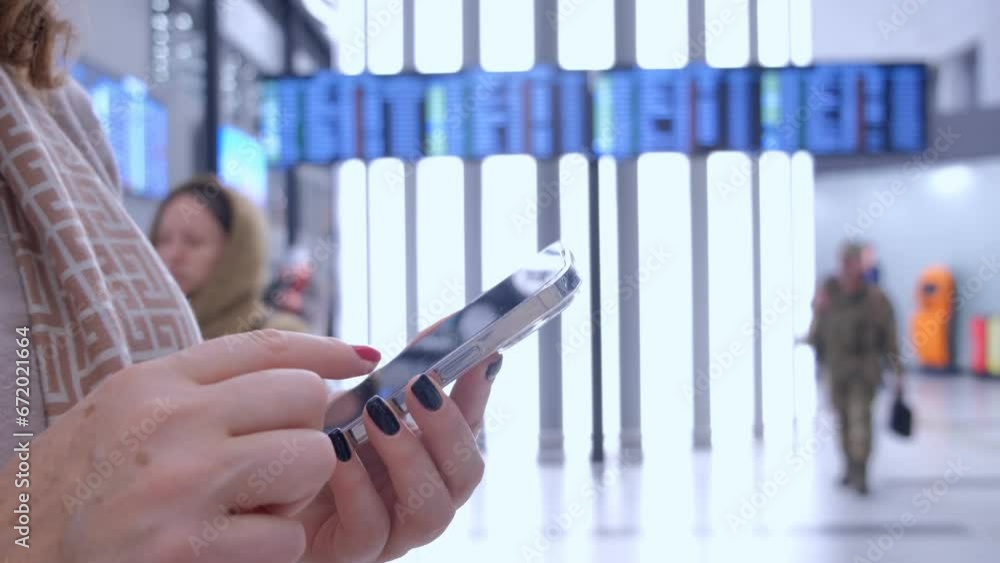 Close-up. People in international airport. Female traveler look at ...