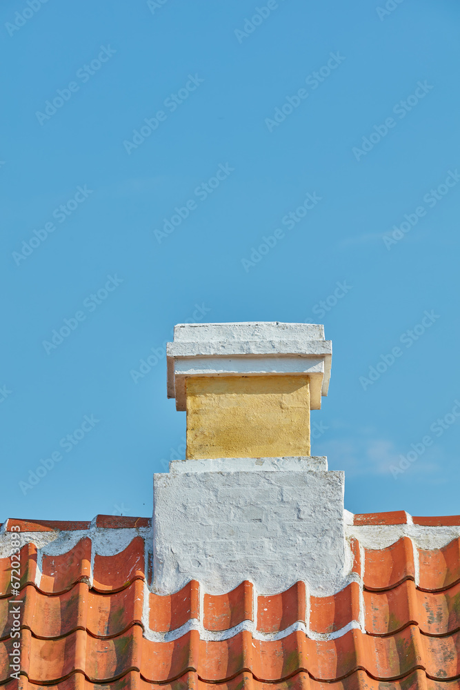 Brick chimney designed on slate roof of house building outside against ...