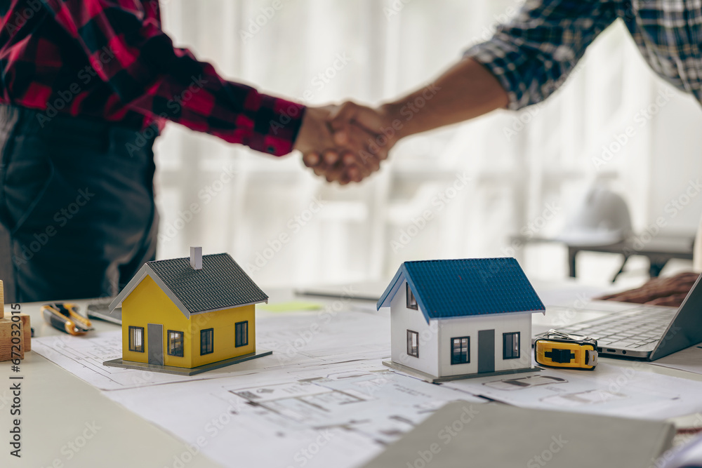 Construction workers greet each other with a handshake. Construction ...