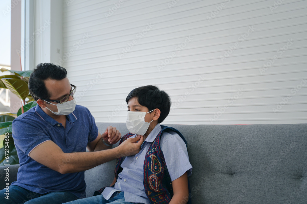 Indian father help his son wearing medical mask to protect Coronavirus ...