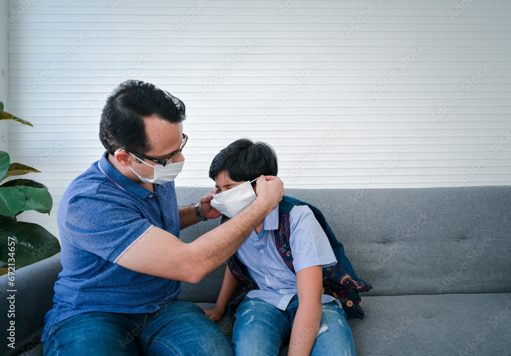 Indian father help his son wearing medical mask to protect Coronavirus ...
