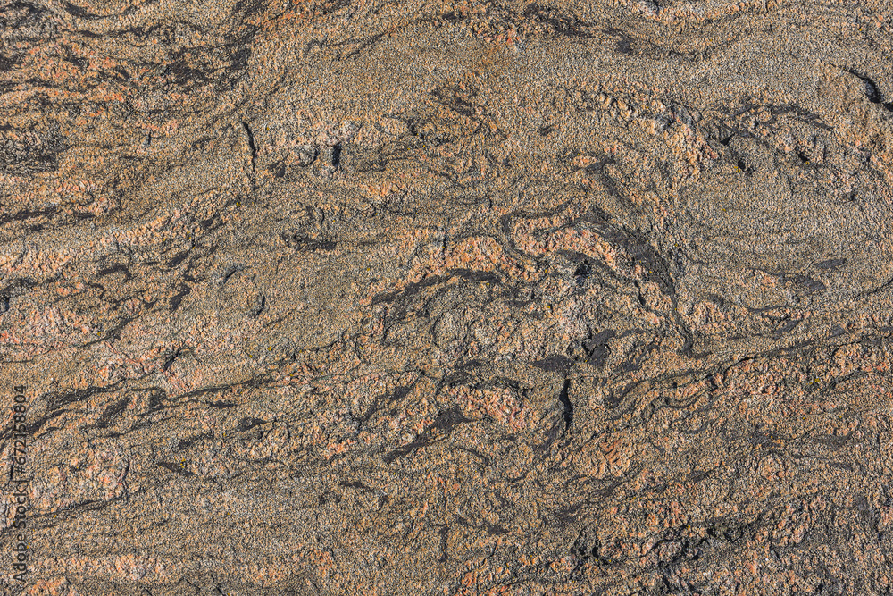brown granite structure with wavy curved lines and a small line break ...