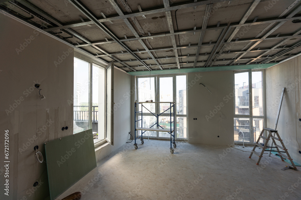 Drywall installation work in progress by construction workers at ...