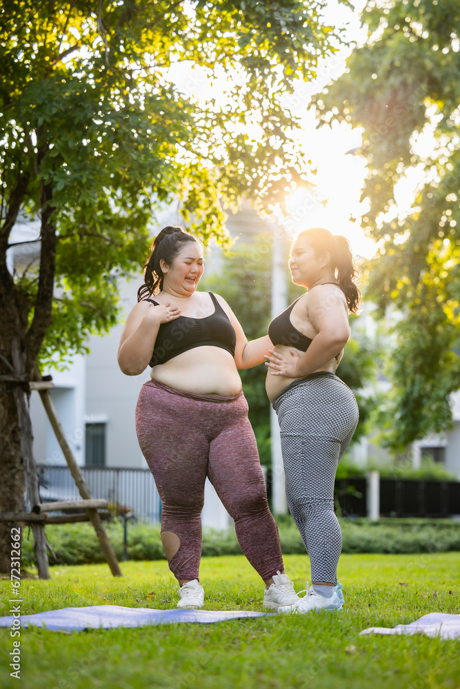 Two Asian woman body fat belly. Obese woman hand holding excessive ...