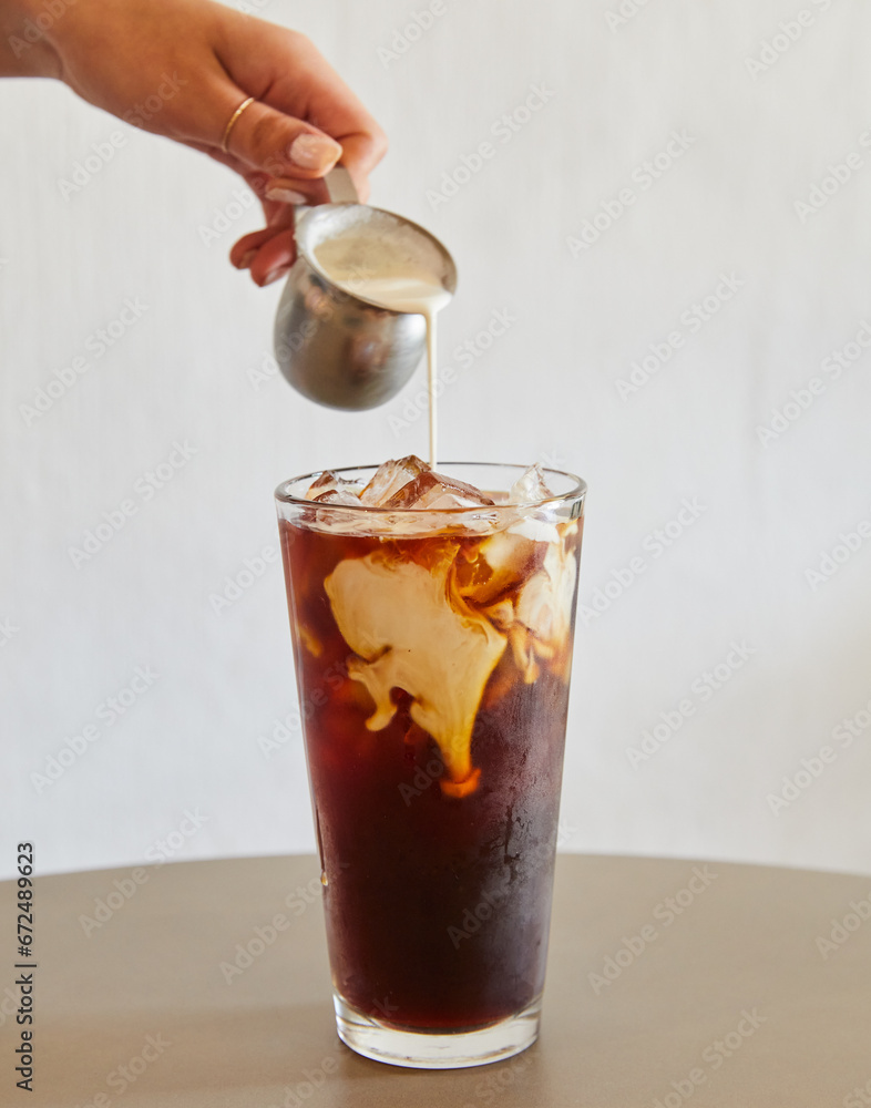Pouring milk over Iced Coffee Stock Photo | Adobe Stock