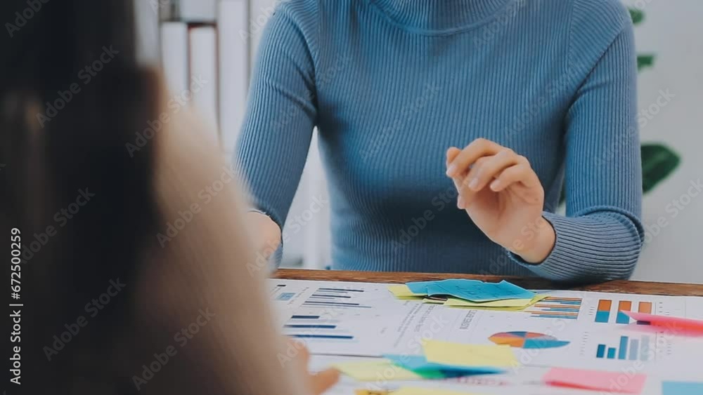 Two creative business people meeting and planning use post it notes ...