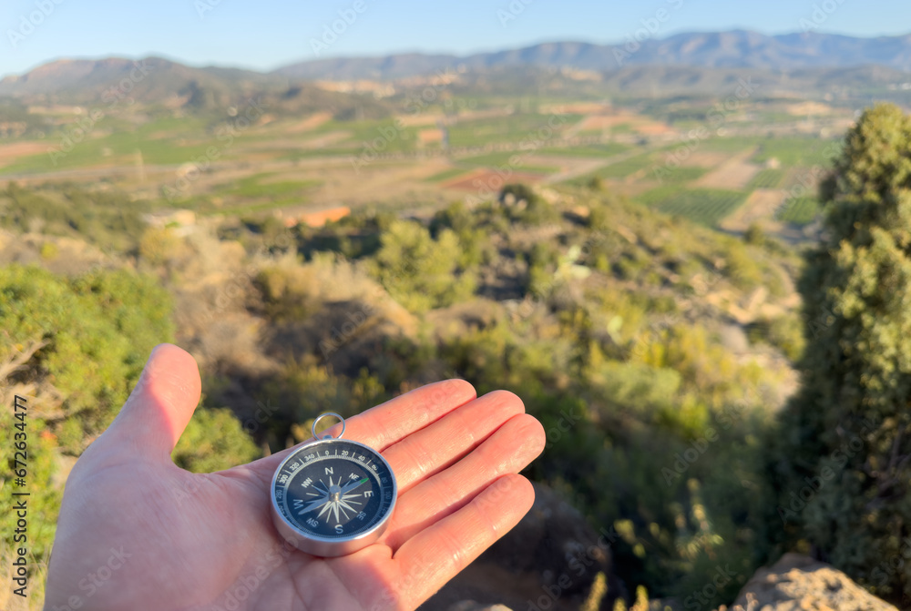 Compass in hand in mountains. Tourist compass for orientation on ...