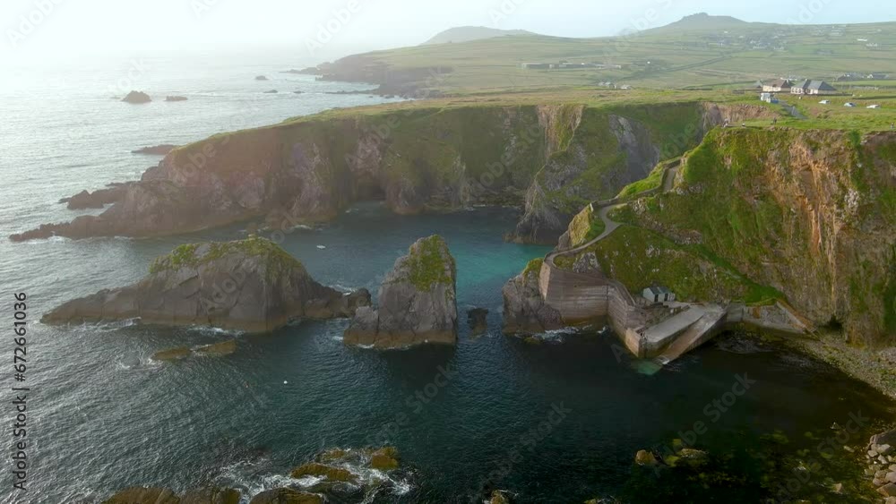 Dunquin or Dun Chaoin pier, Ireland's Sheep Highway. Aerial view of narrow pathway winding down ...