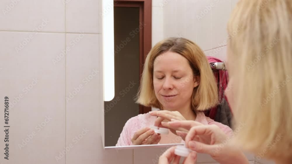 Vidéo Stock contact lenses, woman putting on eye lens in bathroom in ...