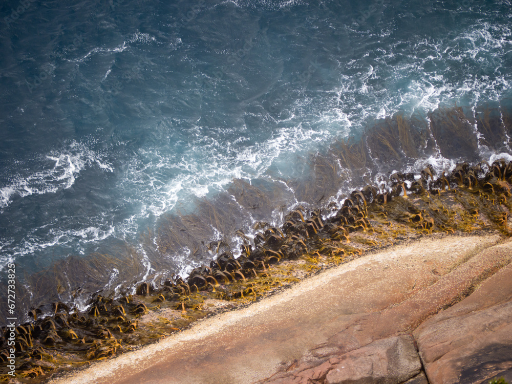 Pretty wave pattern and seaweed viewed from a cliff top Stock Photo ...