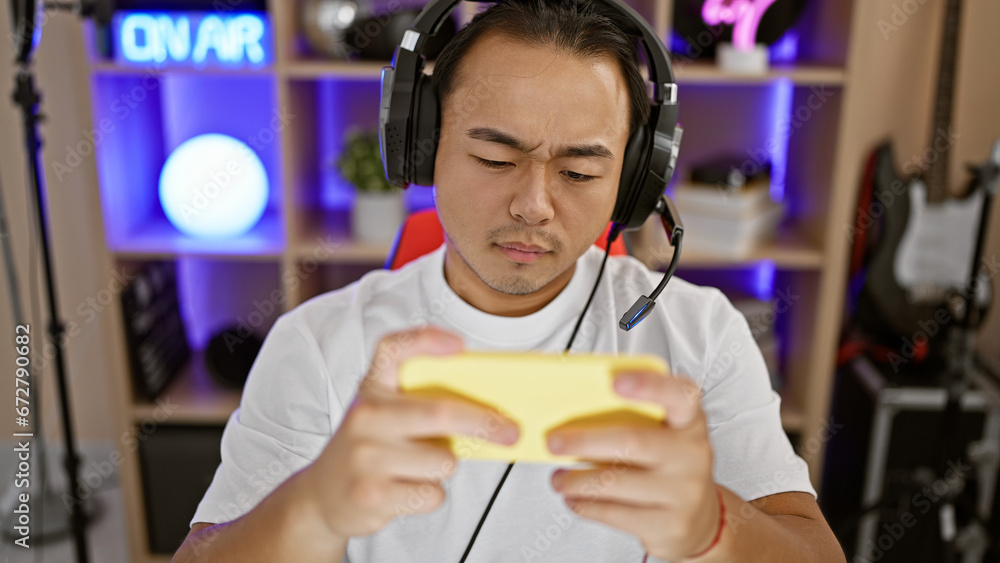 Serious yet relaxed, young chinese streamer concentrates, mastering ...