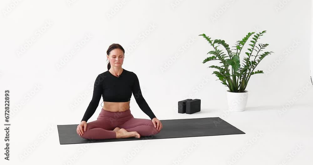 A woman performs the Kapalabhati exercise for the respiratory tract ...