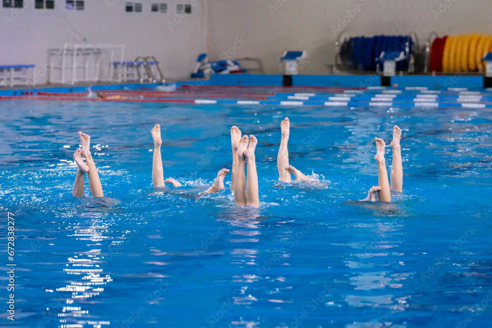 artistic performance in swimming pool, group of women doing synchrone ...