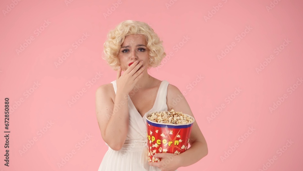 Portrait of an emotional woman crying with a big bucket of popcorn ...