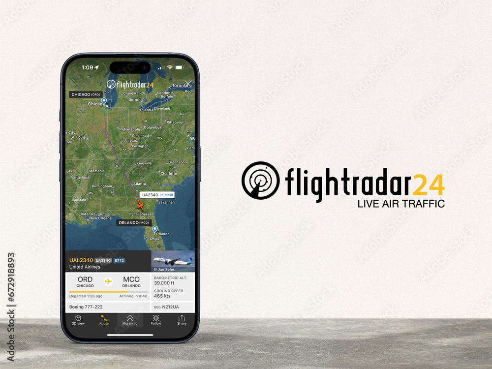 Flightradar24 logo is displayed on a modern smartphone, next to it is ...