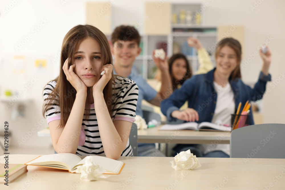 Teen problems. Students bullying their classmate in classroom ...