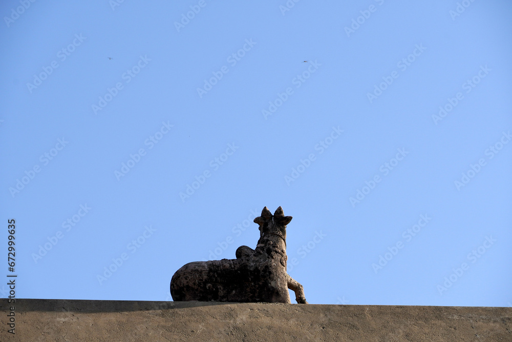 Sacred Cow statue in Hindu temple wall. Holy Nandi animal sculpture in ...