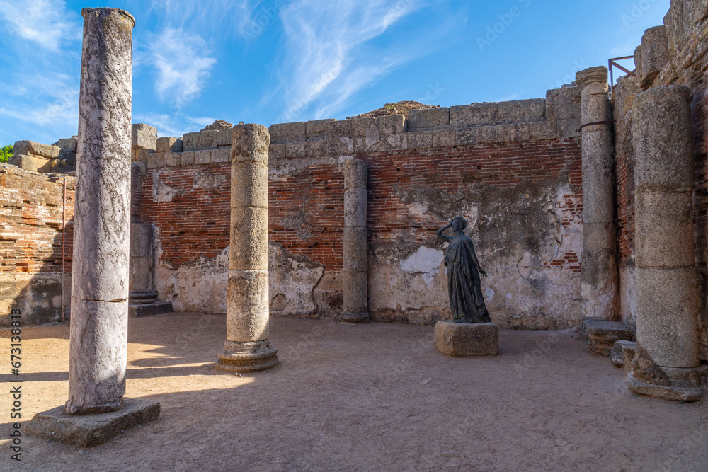 Ruins of a Roman hall with columns and the bronze statue of the actress ...
