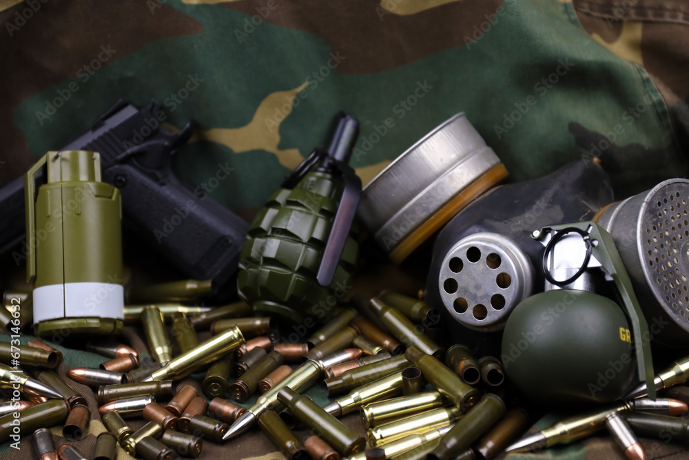 Different types of ammunition and grenades on a camouflage background ...