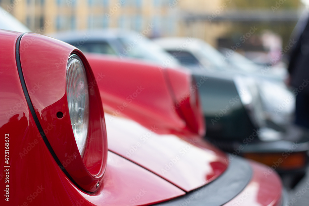 Classic vintage retro red car with round headlights. Street photo close ...