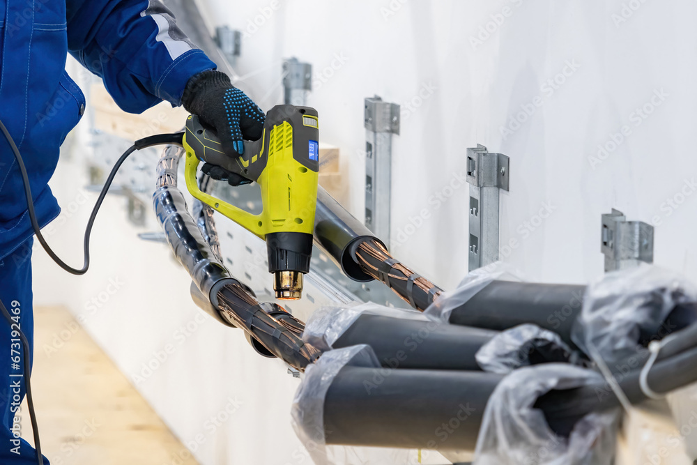 Installation of high-voltage electrical networks. Electrician hand near ...