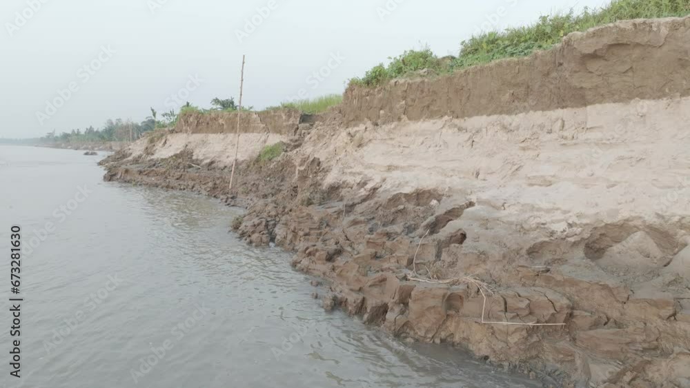 Soil erosion ditch around a running water, wild spring village river ...