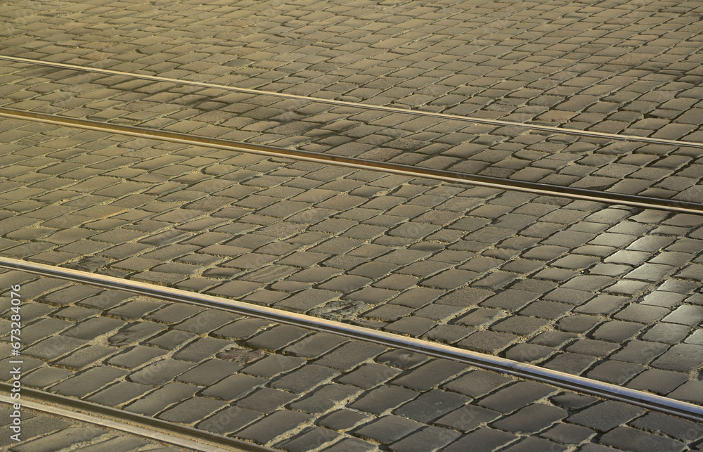 Metal tram rails in the middle of the road, laid out of a smooth paving ...