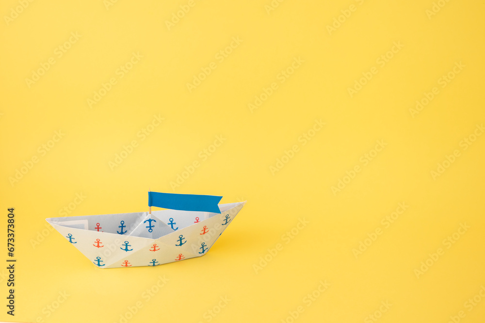 Paper boat with an anchor print, with a flag where you can write, on a ...