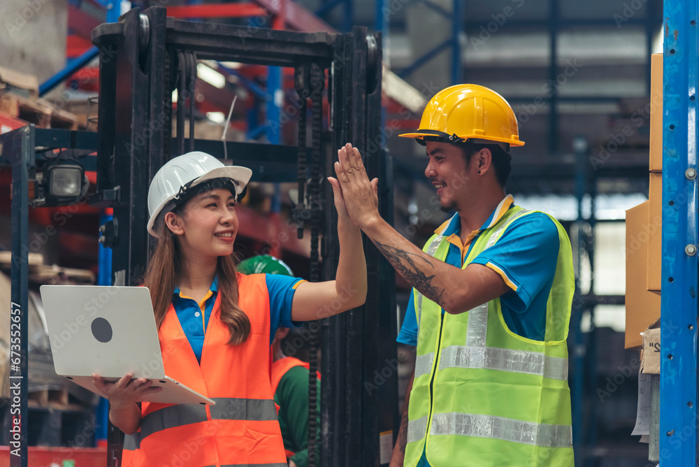 Warehouse management team using computer laptop check stock inventory ...