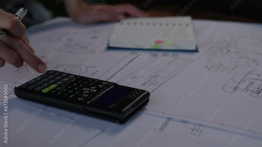 Engineer or architect working and calculations on paperworks blueprints ...