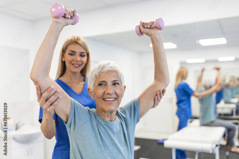 Oder aged woman doing physiotherapy with support from physiotherapists ...