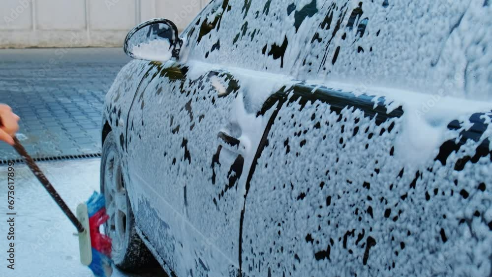 Washing luxury black car on touchless car wash. Cleaning the details of ...