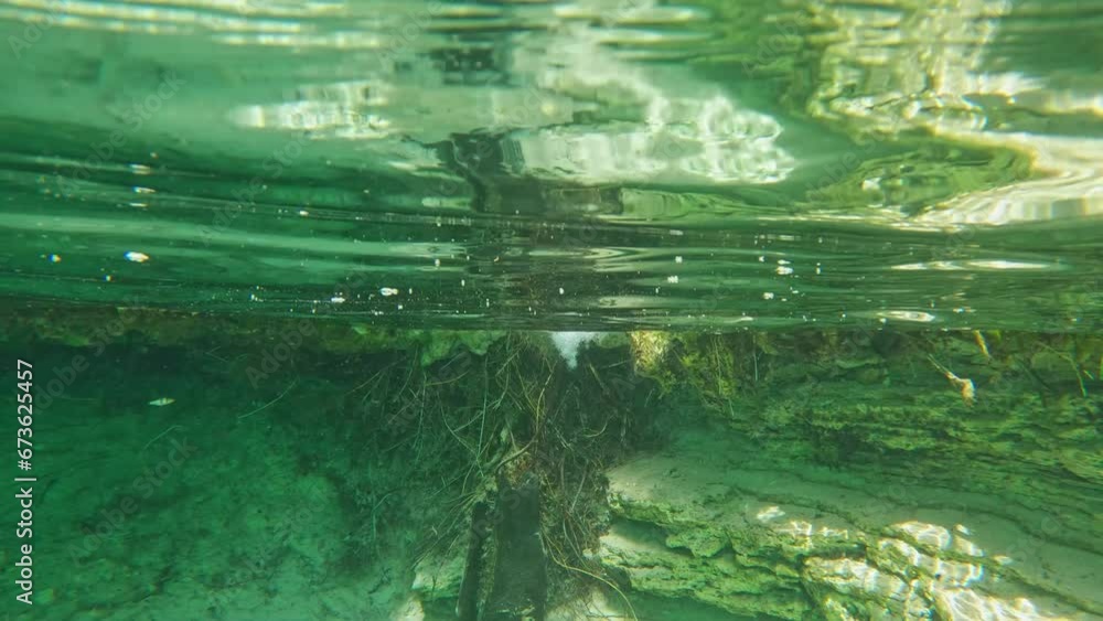 Underwater emerald lake, a stream of clean water flows over the stones ...