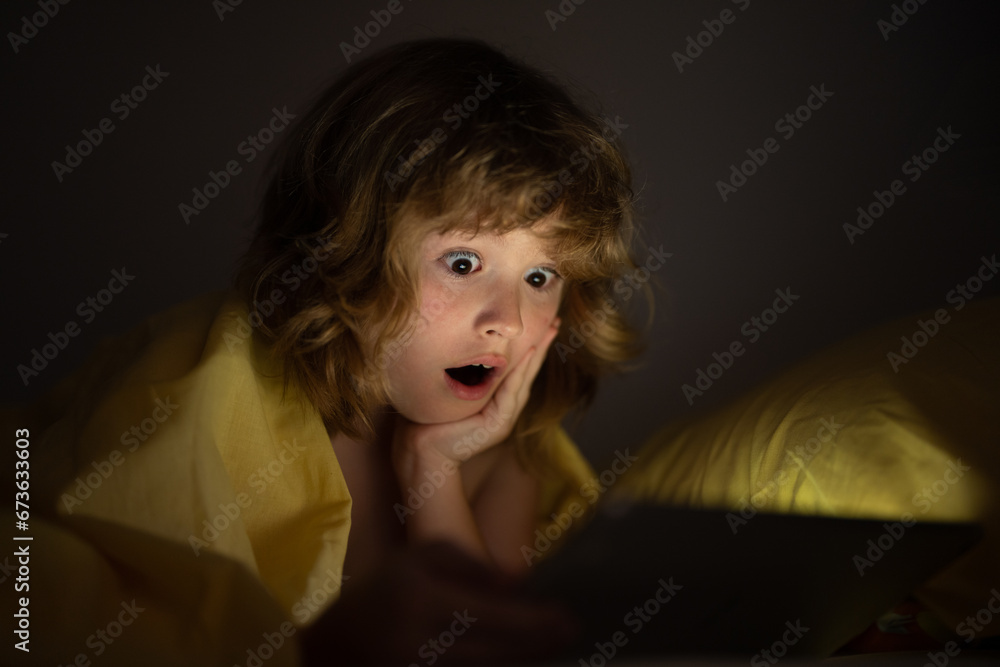 Kid playing on a digital tablet. Kid using tablet for gaming and online ...