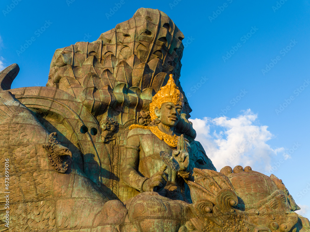 Statue of Hindu god Garuda Vishnu Kenkhana With blue sky and clouds and ...