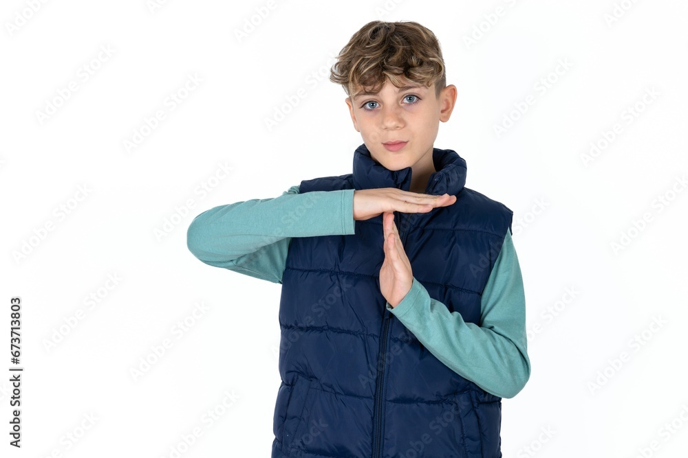 caucasian kid boy wearing blue vest being upset showing a timeout ...