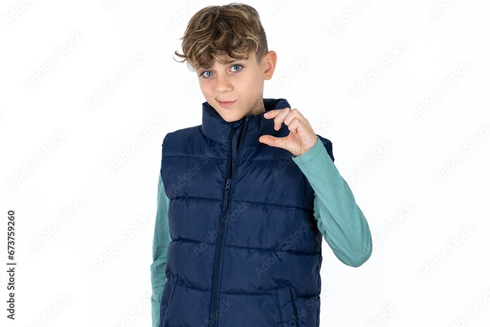 Displeased Caucasian teen boy wearing shapes little hand sign ...