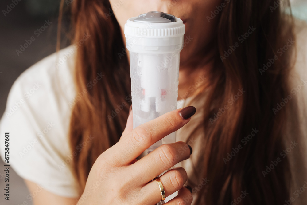 Nebulizer device in mouth. Woman with inhaler in her mouth background ...