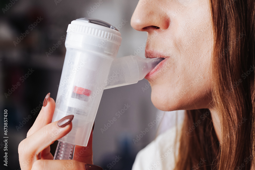 Nebulizer device in mouth. Woman with inhaler in her mouth background ...