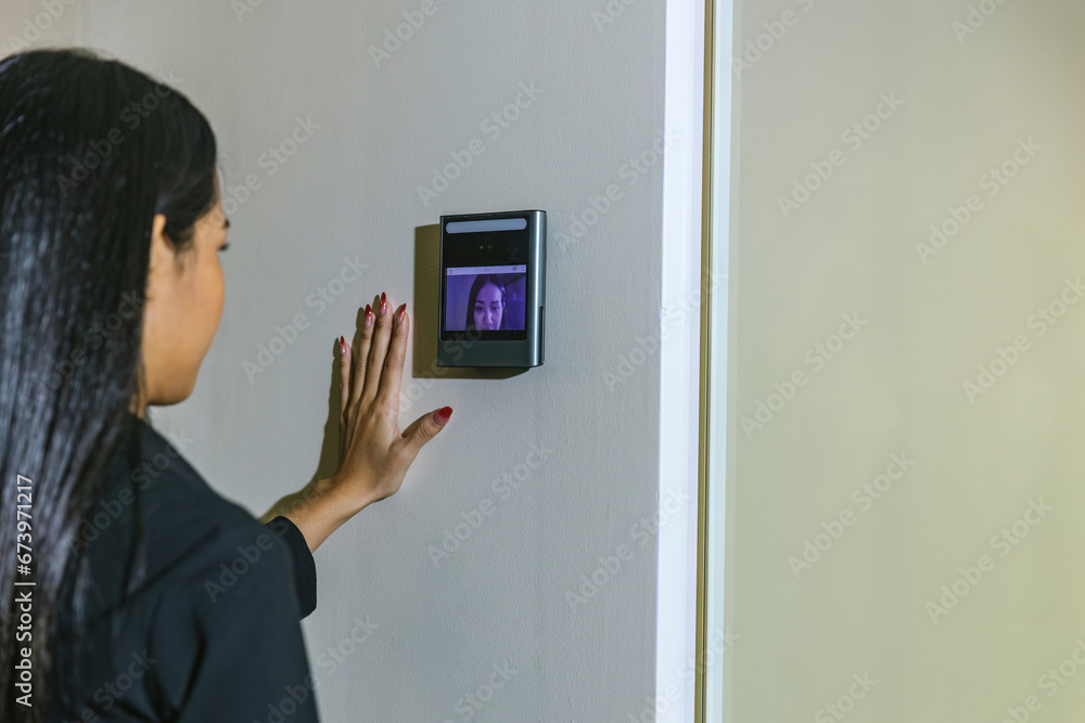 Woman using face scanner to unlock door in office building. Access ...