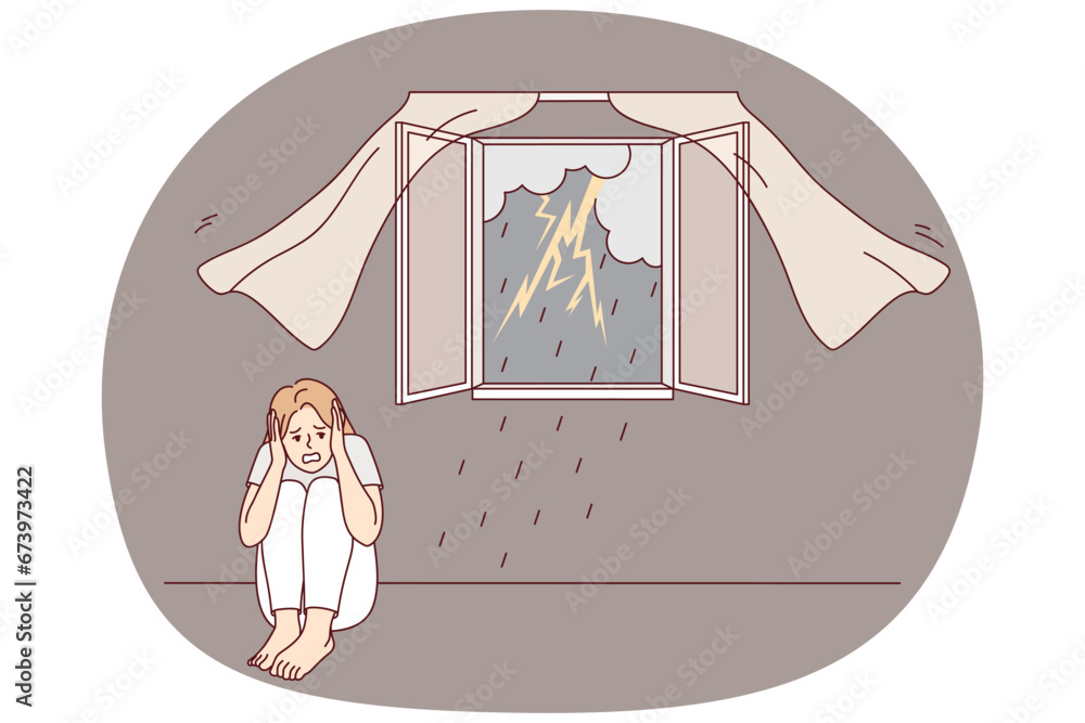 Scared girl sitting on floor afraid of storm outdoors. Terrified young ... Scared girl sitting on floor afraid of storm outdoors. Terrified young ...