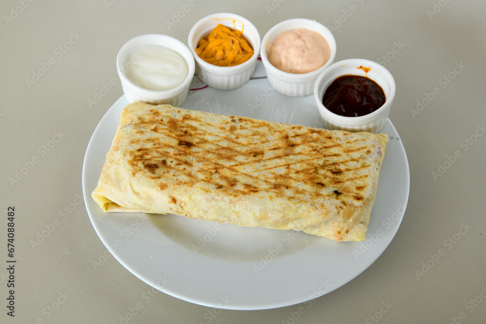 Lavash doner kebab ( zurna doner durum ) or shawarma sliced in plate ...
