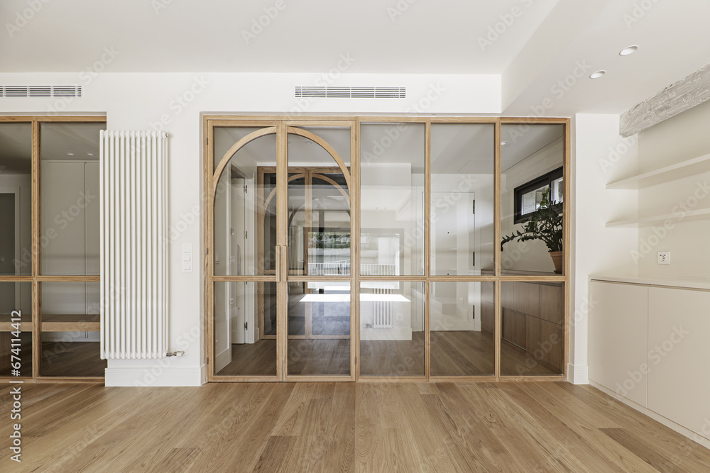 Empty modern living room with custom-made furniture on one wall and a ...